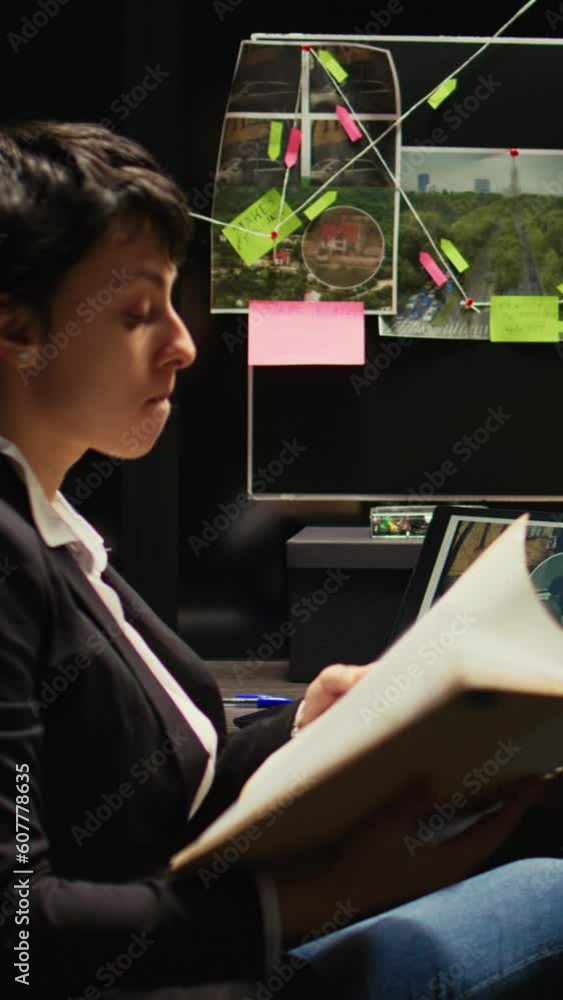 Vertical video Detective browsing through case files to uncover new incriminating proof while ...
