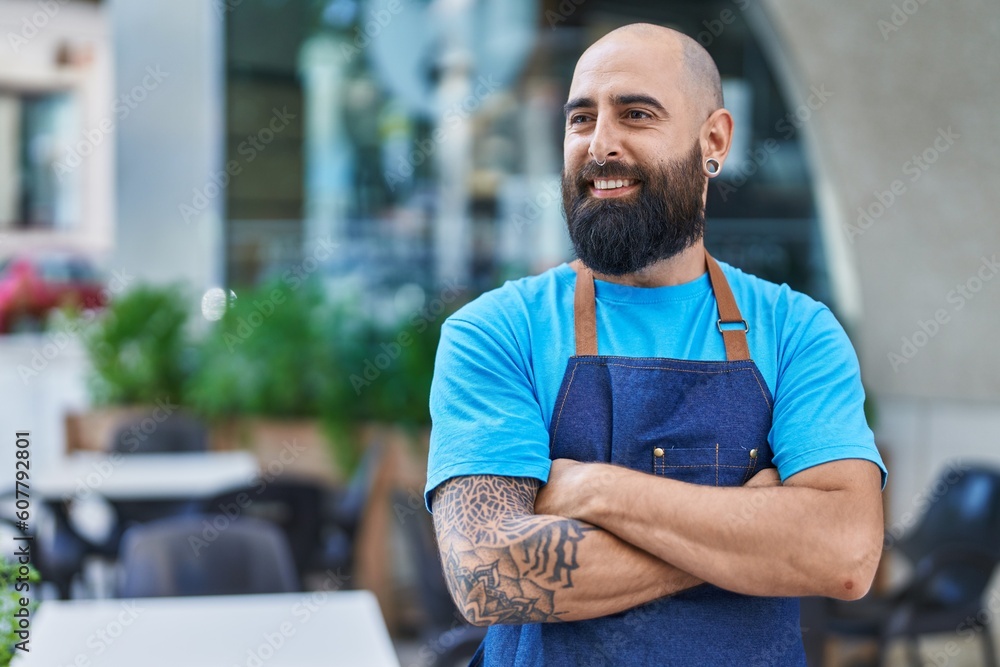 Young bald man waiter smiling confident standing with arms crossed ...