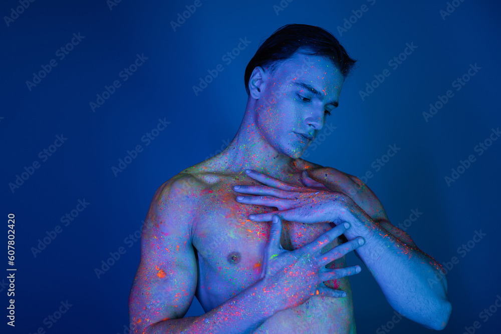 Young Shirtless Man With Muscular Body Touching Bare Chest While Posing