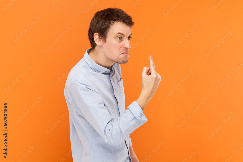 Side view portrait of angry rude man standing looking away with ...