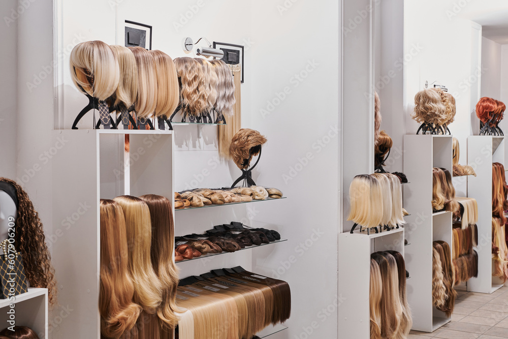 Showcase of natural looking wigs in different colors fixed on the metal ...