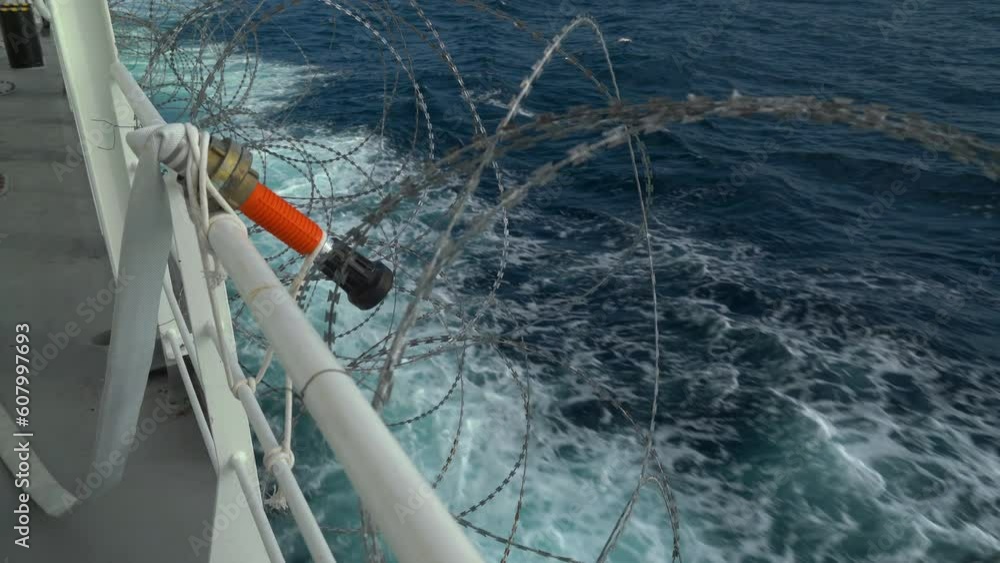 Barbed wire on railing of vessel. Protection from pirates. Open deck in ...