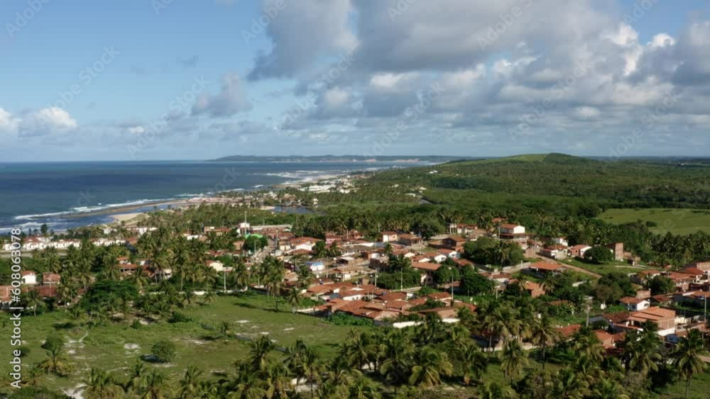 Rising aerial drone wide shot of the tropical village of Sibauma in ...