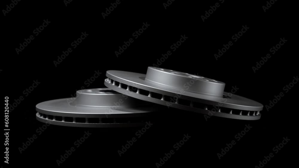 Pair of rotor braking disks isolated in dark studio, black background ...