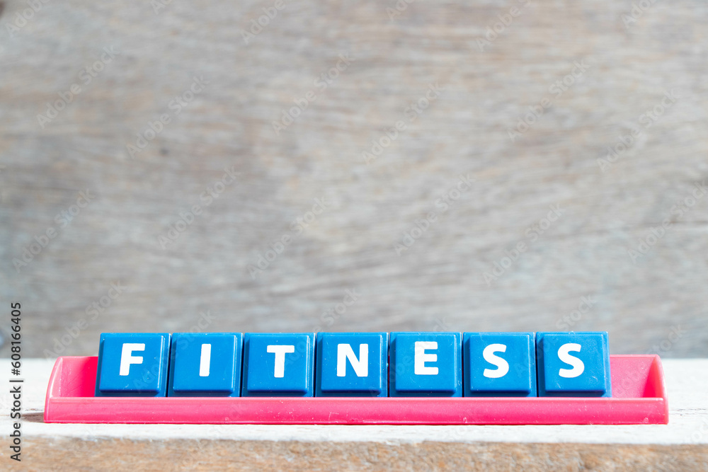 Tile alphabet letter with word fitness in red color rack on wood ...