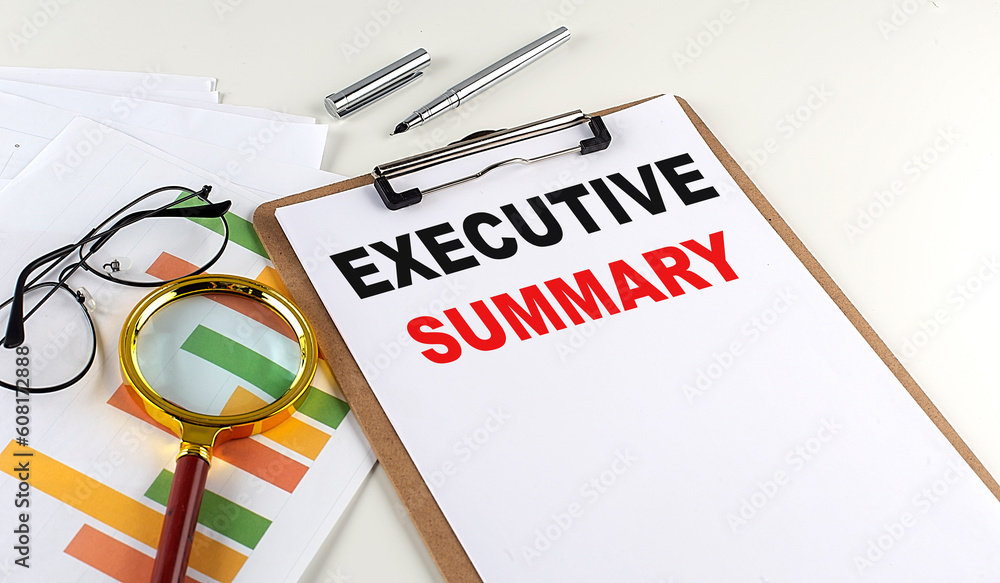 EXECUTIVE SUMMARY text on clipboard with chart on white background ...