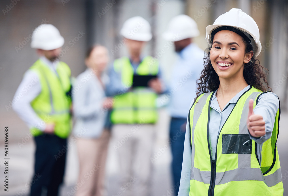 Thumbs up, woman construction worker and at a industrial workplace ...