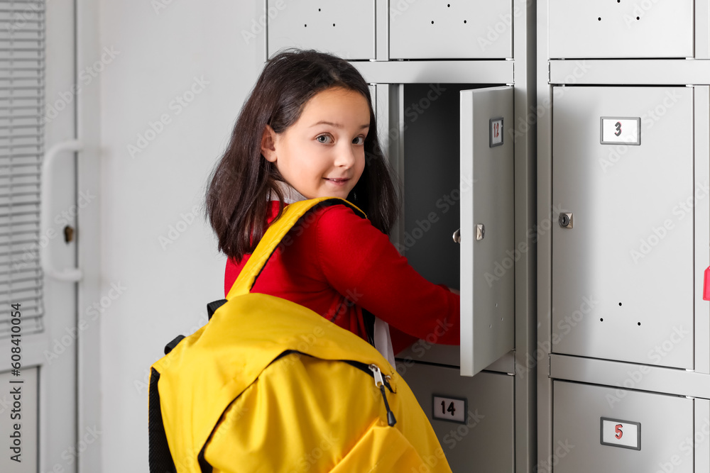 Little girl with backpack opening her locker at school Stock Photo ...