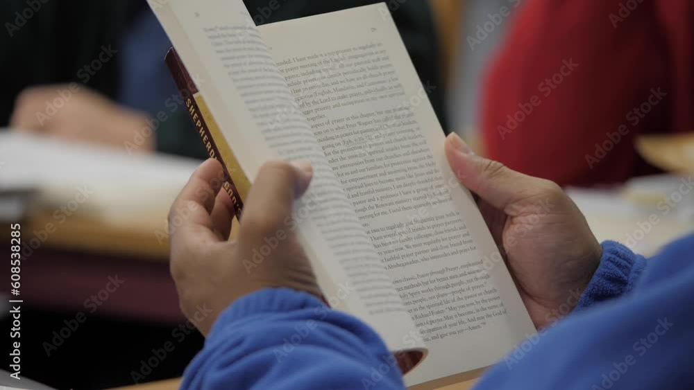 close up african american with book reading hands in prison black ...