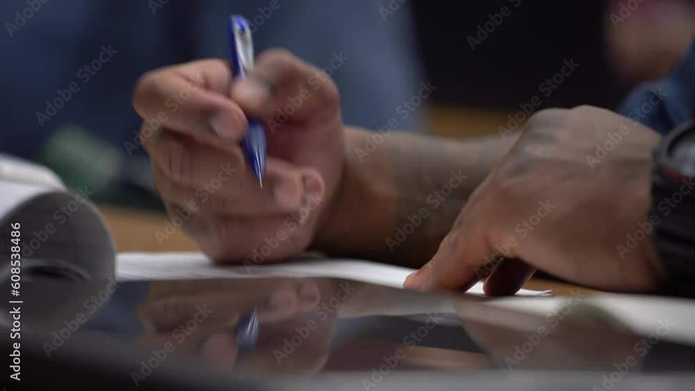 close up african american with papers writing hands in prison black ...