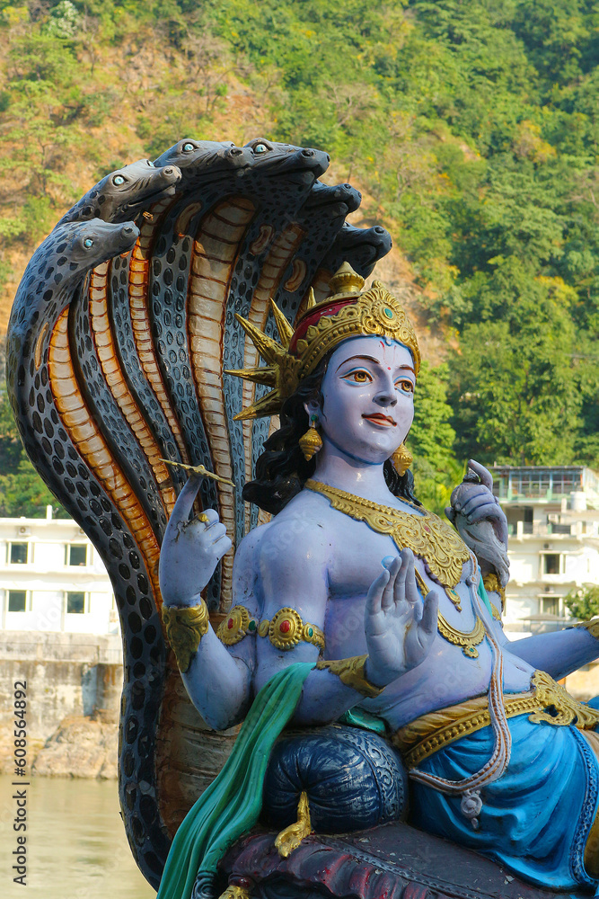 Lord Vishnu is seated on the snake Ananta Shesha. Hindu religious ...