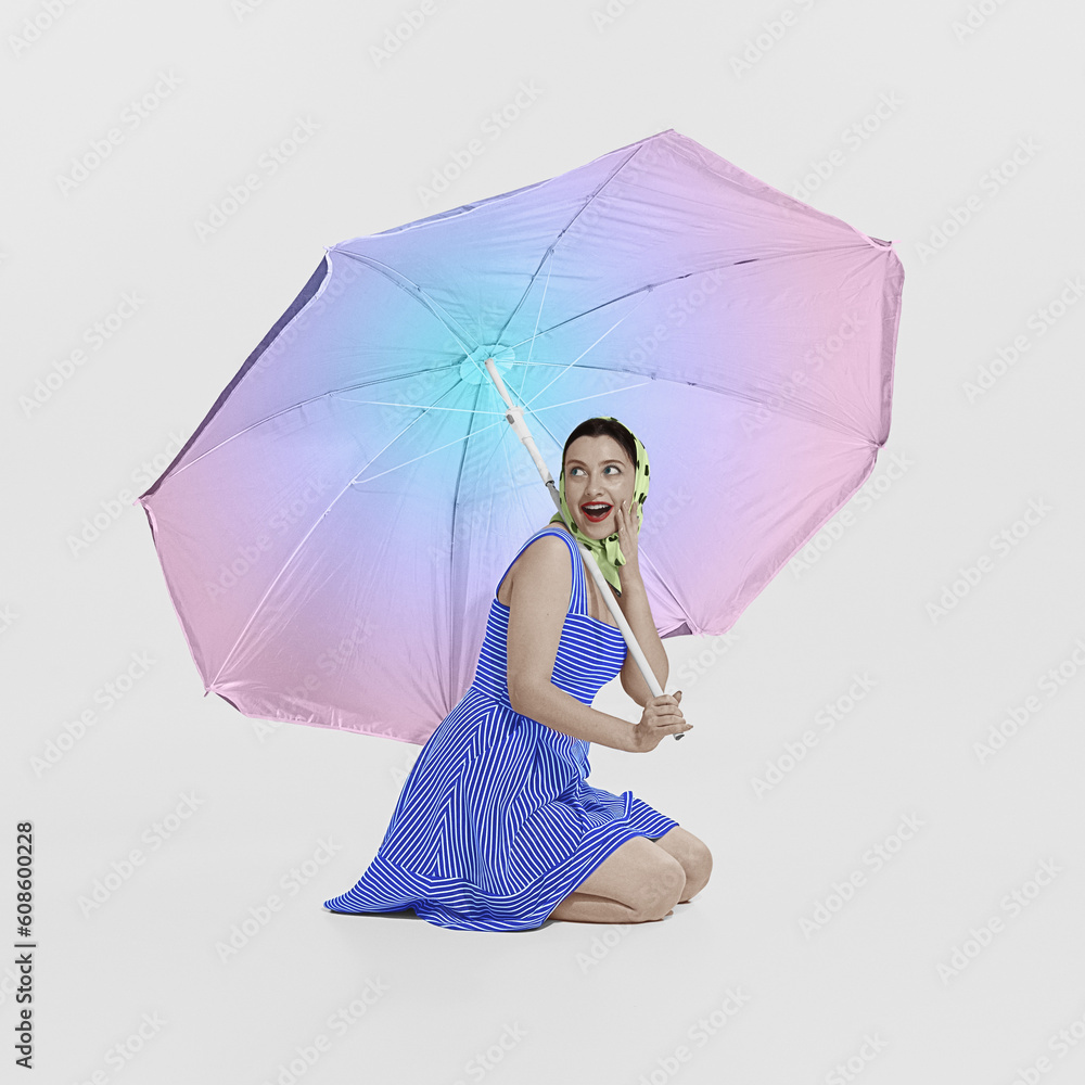 Happy excited young beautiful girl sitting under big sun beach umbrella ...