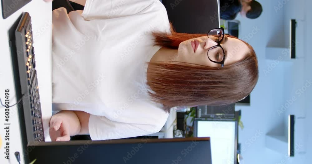 Vidéo Stock Vertical shoot. Female employee of company in glasses ...
