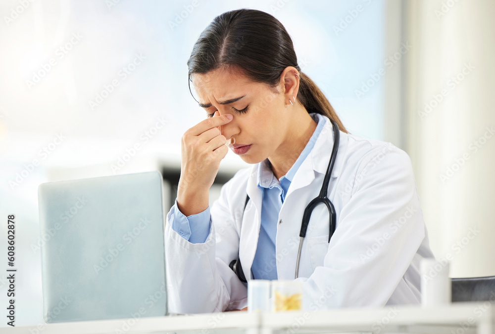 Mental health, woman doctor sad and with laptop at her desk in a modern ...