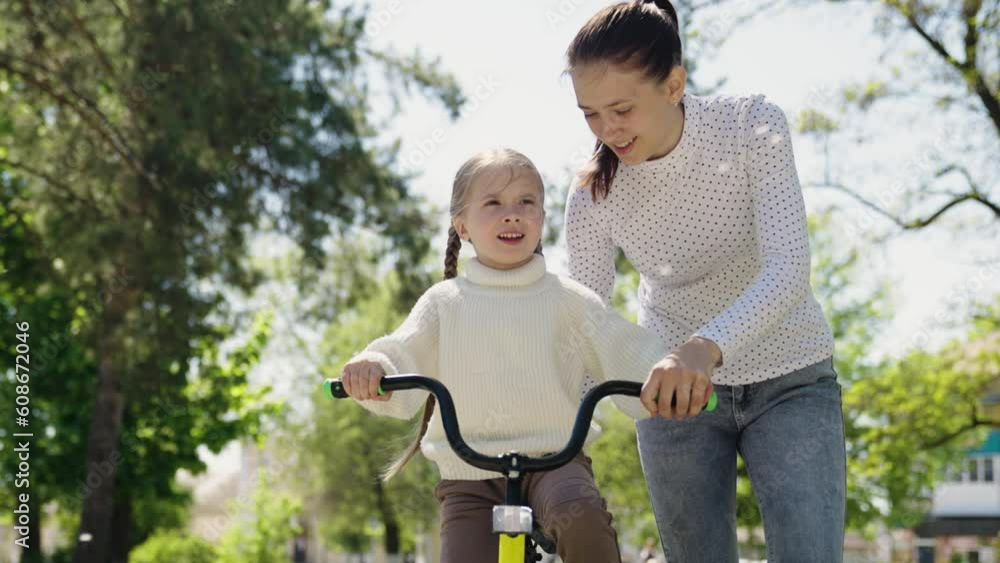 child learn ride bike. mother daughter girl park. happiness smile ...