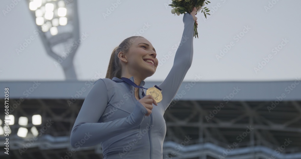 Young Female Athlete Celebrates a Win on a podium, receives a gold ...