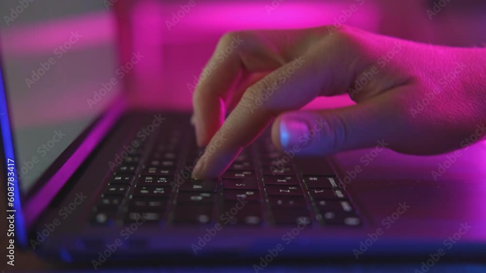 Person typing at laptop computer at night. Male uses keyboard, shakes ...