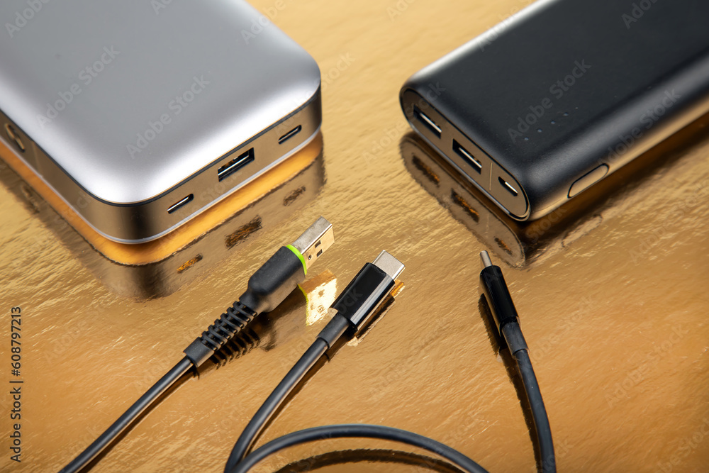 Powerbank portable on a golden background. Electronic devices for ...