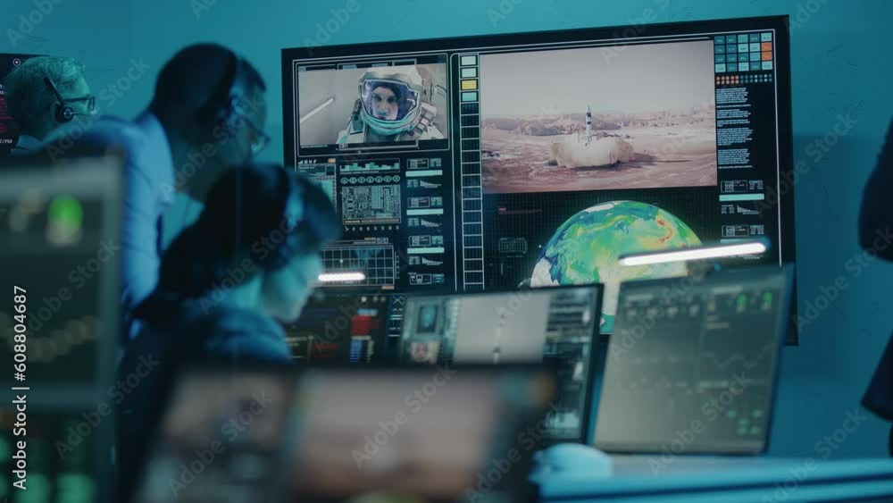 Flight control operators monitor space mission on computers in command ...