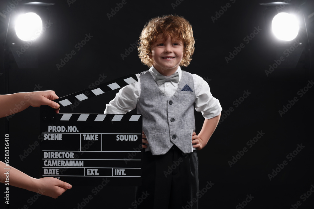 Smiling cute boy performing while second assistant camera holding ...