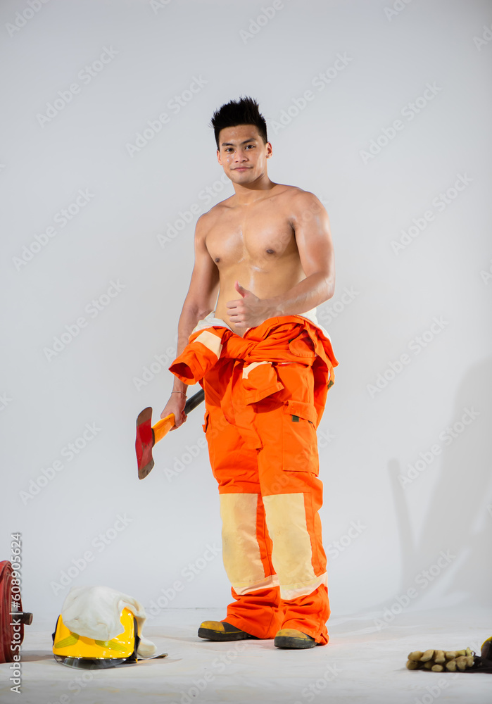 Professional firefighter topless standing one hand holding an iron axe ...