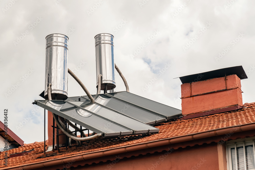 Barrels and solar panels for heating water from sun rays in plumbing of ...