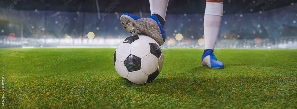 Feet of soccer player step on soccer ball for kick off in sunny stadium ...