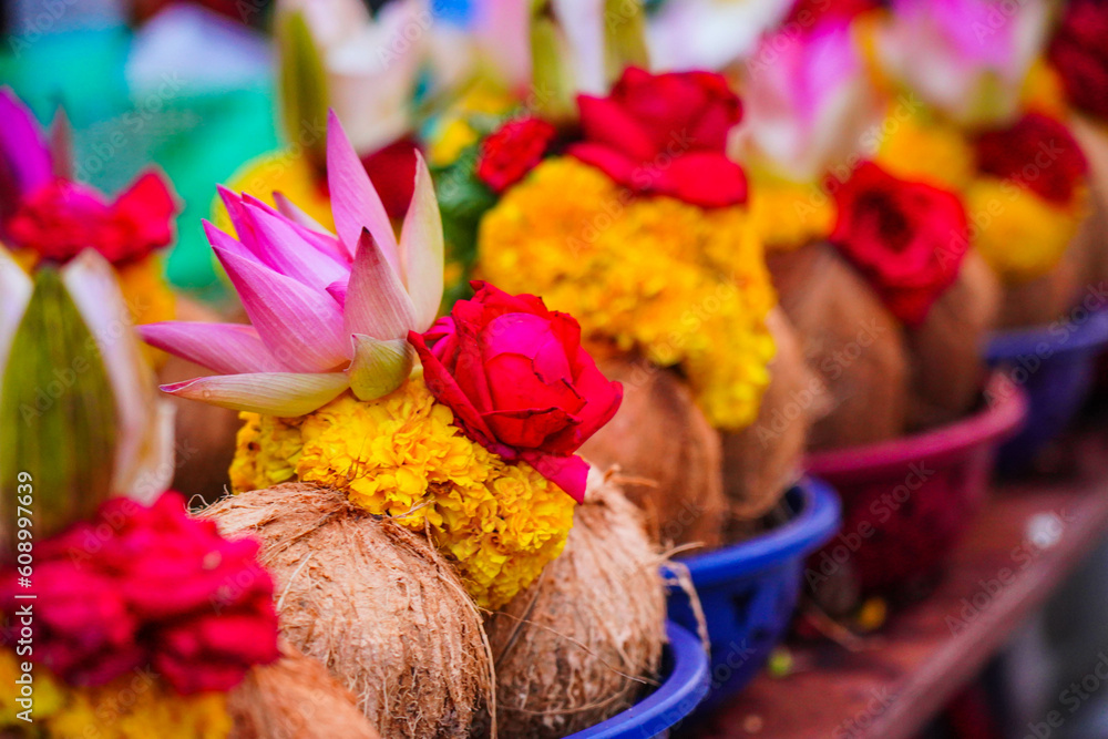 Pealed coconuts, lotus , rose and other flowers prepared for pooja ...