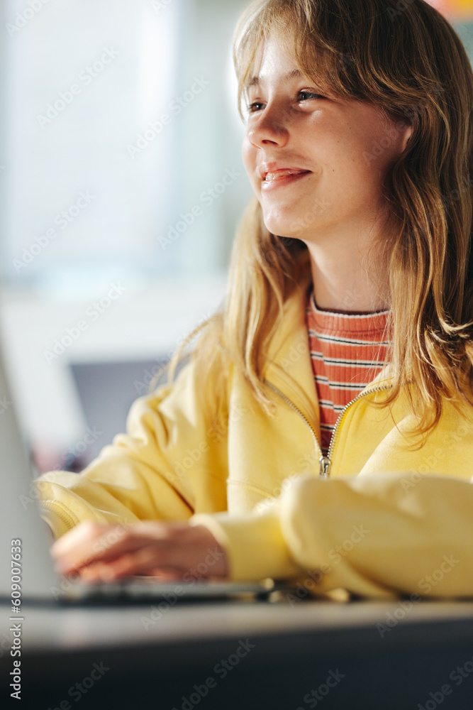 Excited to learn, young girl smiles as she pays attention to a lesson ...
