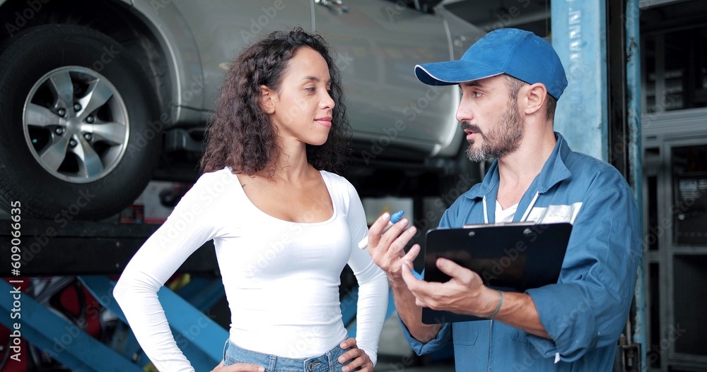Automotive mechanic man in uniform explaining checklist car maintenance ...