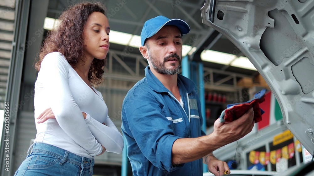 Automotive mechanic man in uniform open vehicle checking up and ...