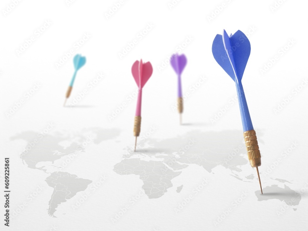 Foto de 4 darts on a world map symbol of travel fist dart target is ...