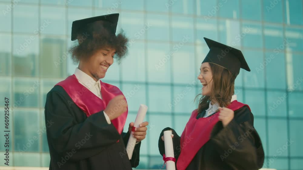Graduates Showing to Each Other Their Diplomas on Background of ...