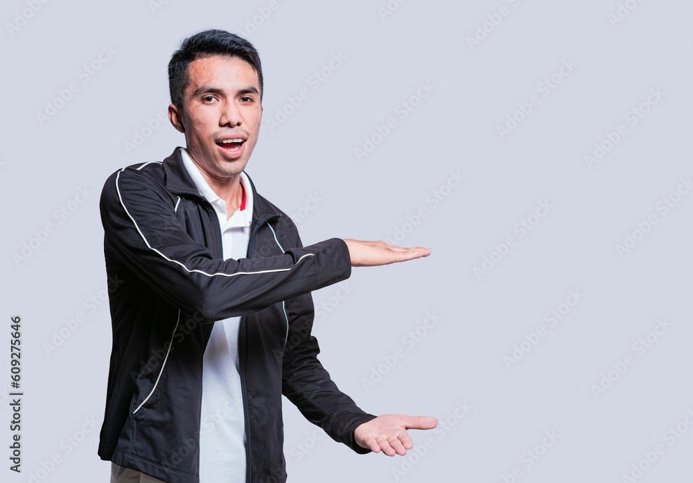 Smiling person showing an object with his palms, surprised man showing ...