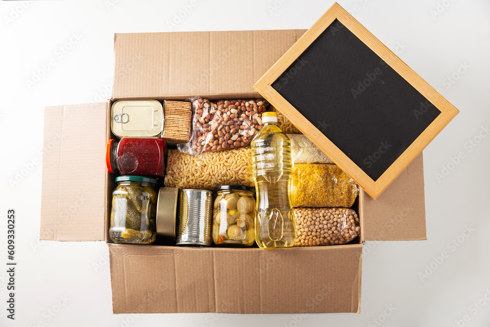 food storage, donation and eating concept - close up of box with ...