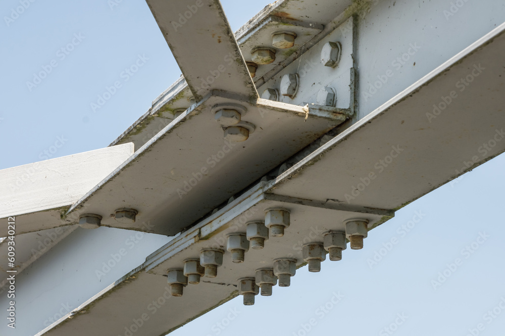 Bolts and nuts on metal plates of steel structure of heavy duty ...