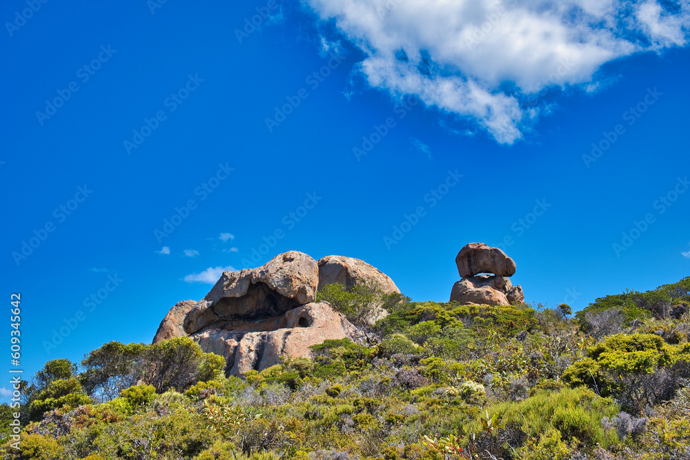 Granitic rock formation with balancing rock rising up from the coastal ...