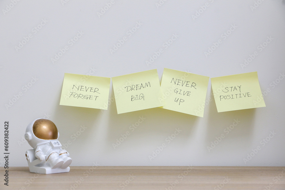 Motivation and inspiration concept, four yellow sticky notes stuck ...