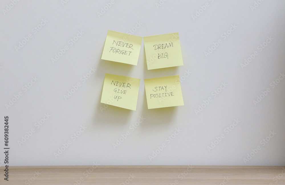 Inspiration concept, four yellow sticky notes stuck on wall featuring ...