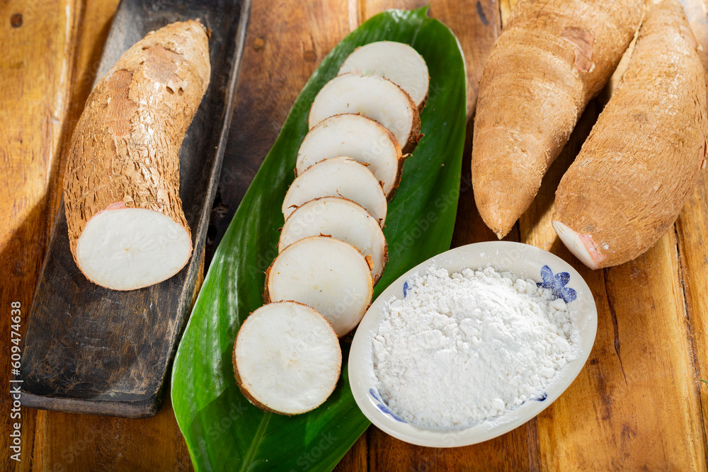 pile of cassava, cassava and cassava flour on a background of rustic ...