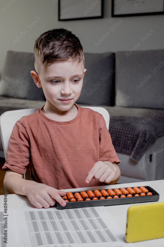 Little preschooler counting large numbers on his fingers using mental ...