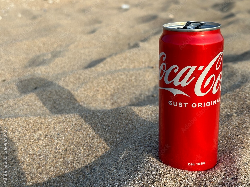 coca cola. the can of coca cola on the fine sand of a beach. photo ...