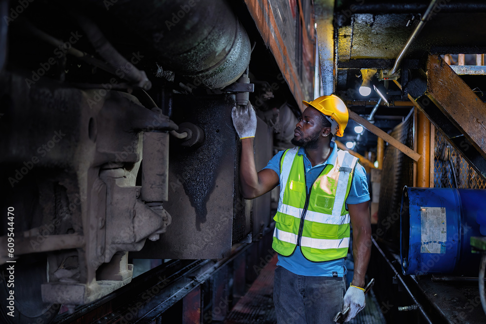 Engineer railway wearing safety gear checking train transmittal system ...