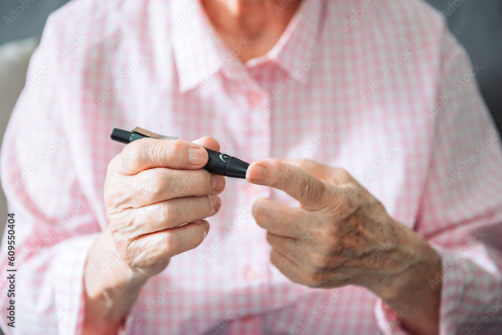 Diabetic mature woman hold use blood glucose meter, old senior adult ...