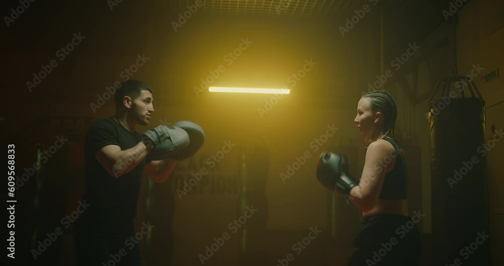 Stockvideon man coach training sportswoman in fight club, lady ...