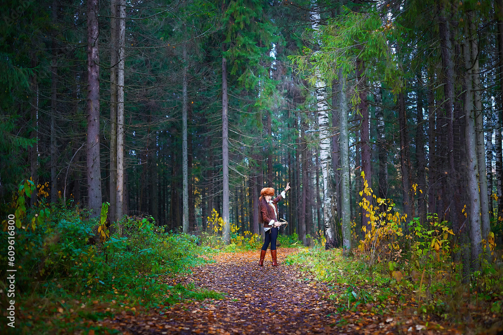Girl in a leather jacket, a big red fox fur hat and with a crossbow in ...