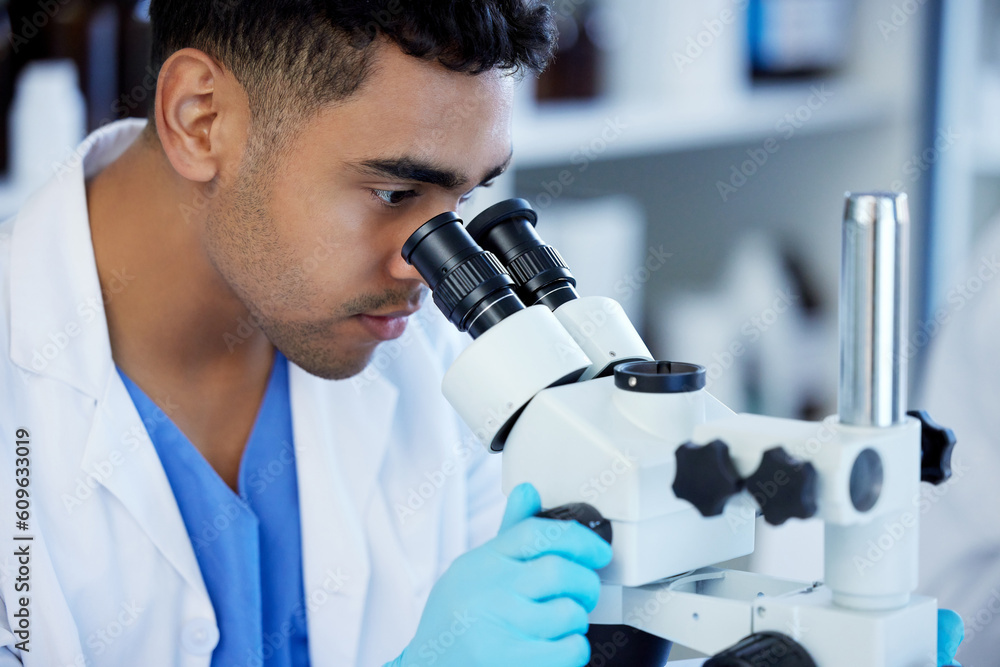 Person Looking Through Microscope