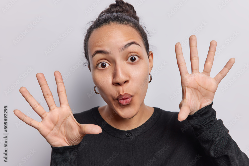 Human face expressions. Surprised dark haired woman tries to have ...