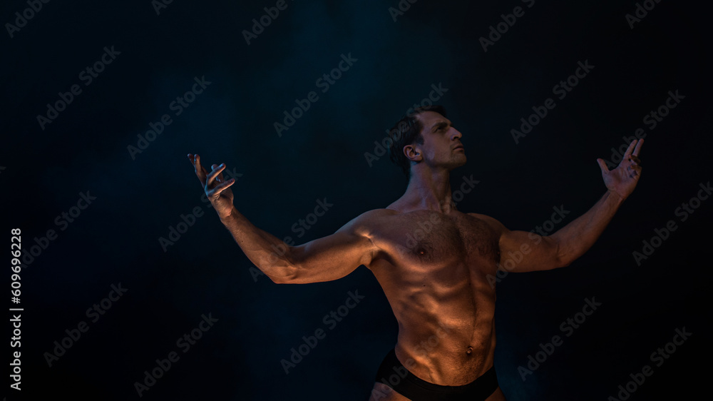 A muscular athlete in an epic pose, fog and smoke on the background ...