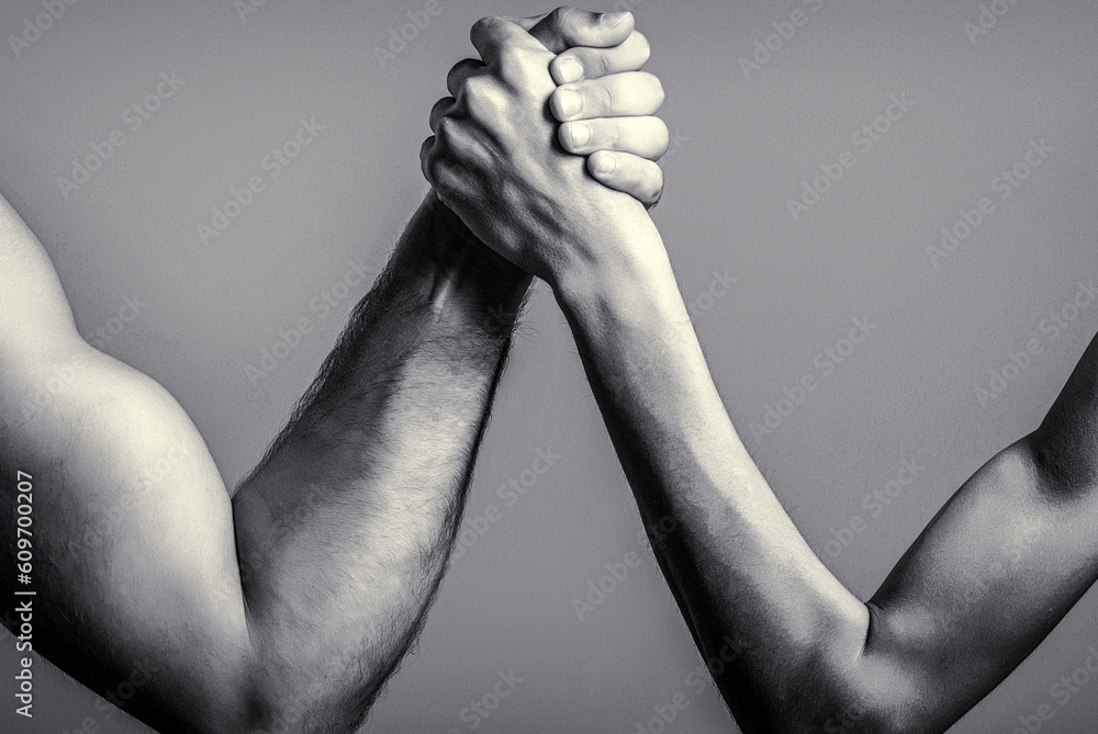 Two man's hands clasped arm wrestling, strong and weak, unequal match ...